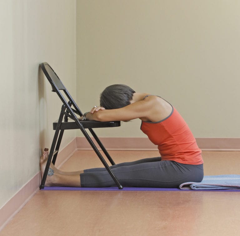 Paschimottanasana forehead rests on chair seat 5495 – Right to Joy